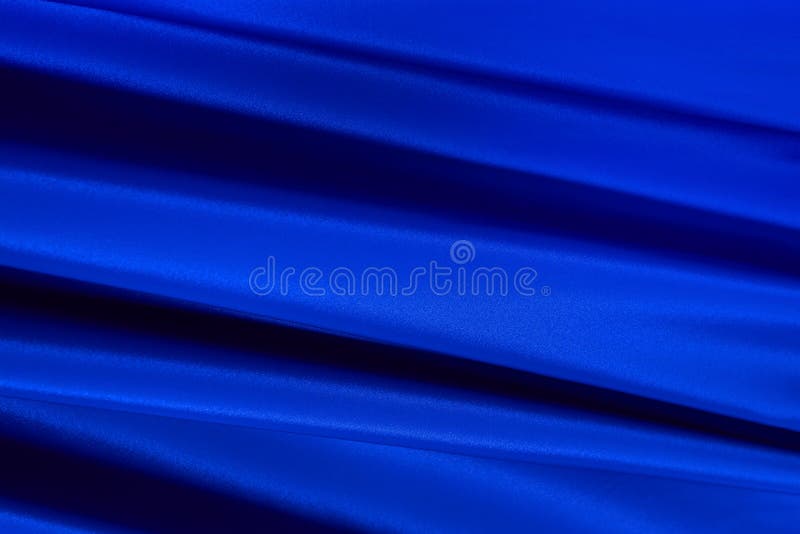 The Texture of a Luxurious Smooth Fabric in Blue with Folds and Waves ...