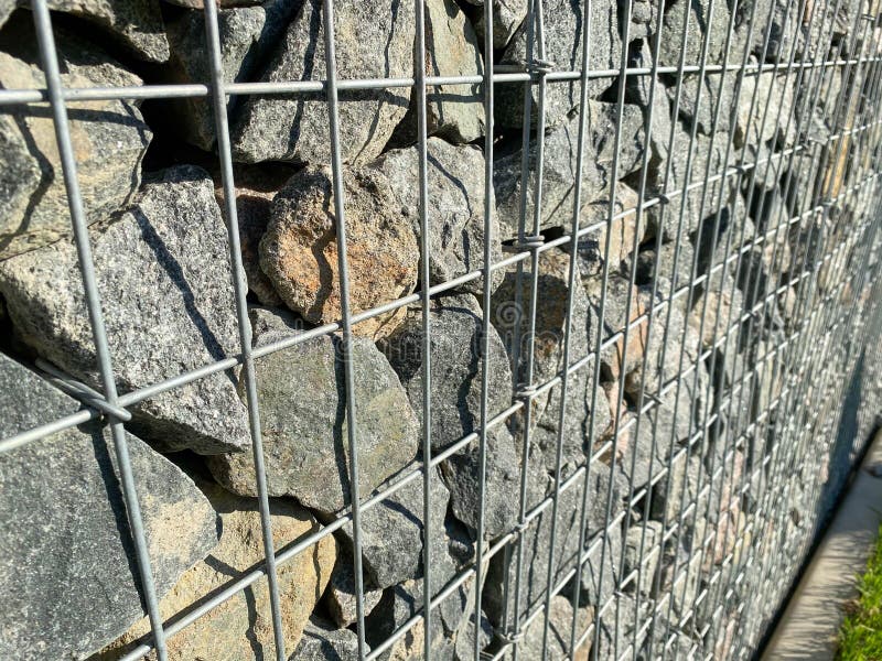 Texture of Metal Wire Mesh and Large Stones Cobblestones Inside. the ...