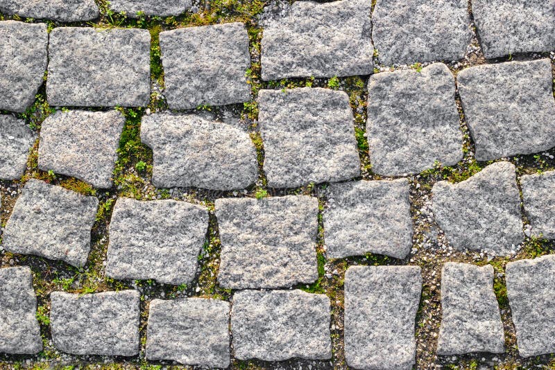 Texture of Paved Stone Road with Sprouted Grass between Masonry. Stock ...