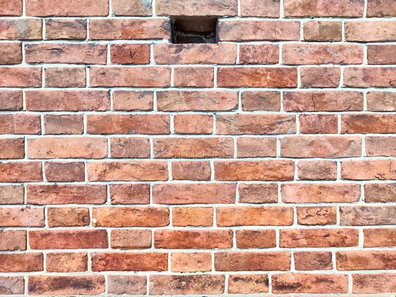 Texture of Red Brick Wall with a Missing Brick Section in Natural Light ...