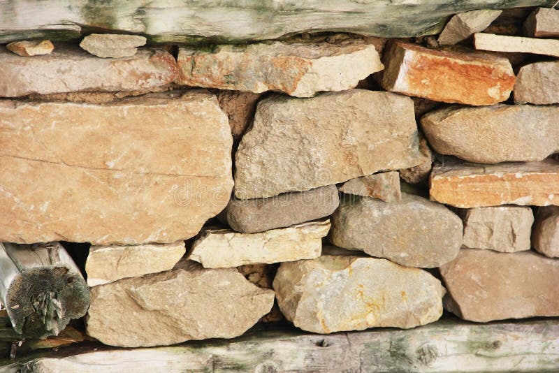The Texture of a Stone Wall Made of Brown Stones and Old Moldy Wood ...