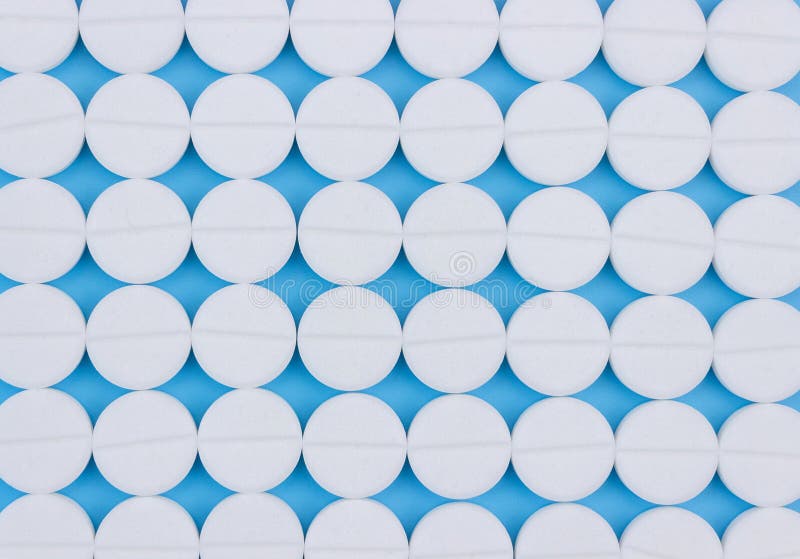 Texture From White Medical Pills On A Blue Background Template For