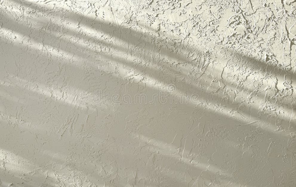A Textured Beige Wall is Partially Illuminated by Diagonal Sunlight ...