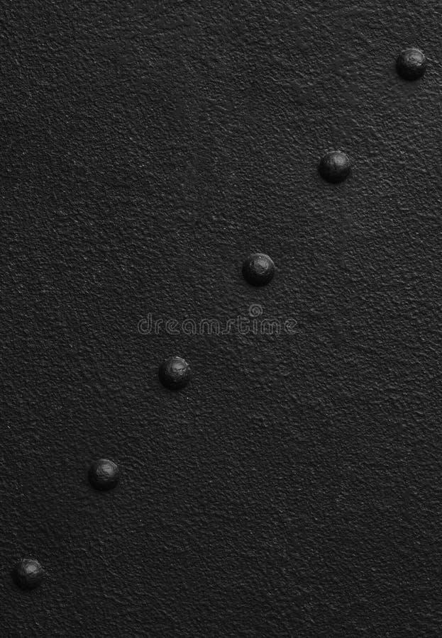 Textured Black Metal Surface with Rivets Creating a Minimalist and Bold ...