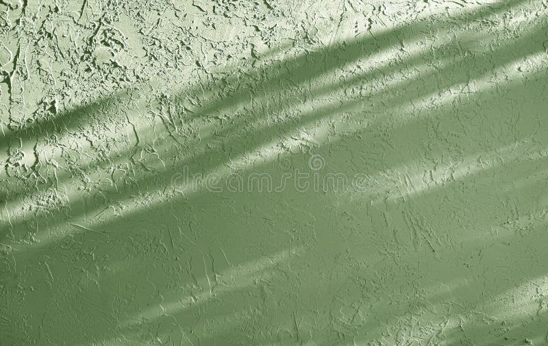 A Textured Green Wall is Partially Illuminated by Diagonal Sunlight ...