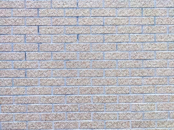 Textured Light-colored Brick Wall with Uniform Layout in Urban Setting ...