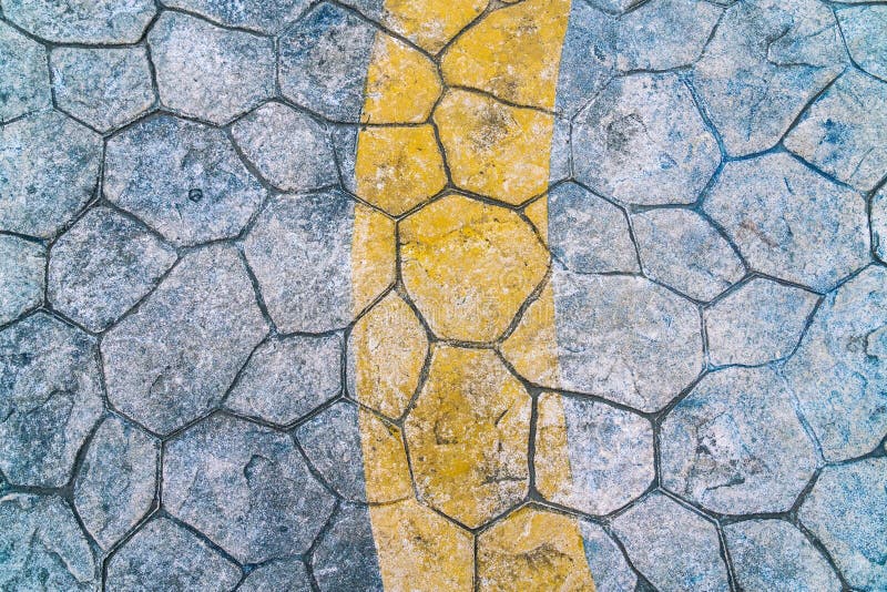 Textured Pavement with a Yellow Line Running through Hexagonal Stones ...