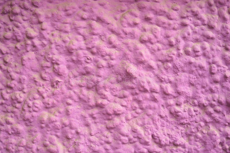 A Textured Pink Wall Surface Featuring Unique Patterns that Catch the ...