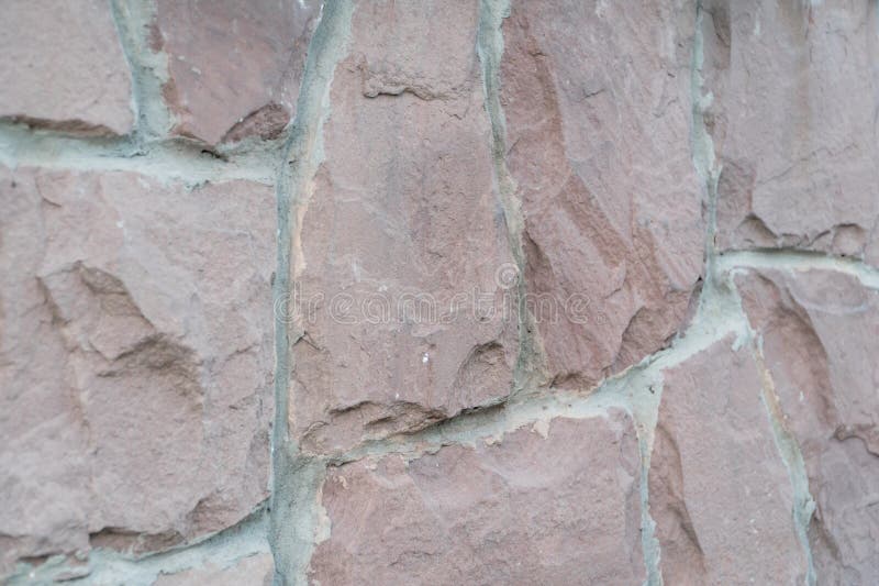 Textured Rustic Brown Stone Wall with Slightly Weathered Appearance ...