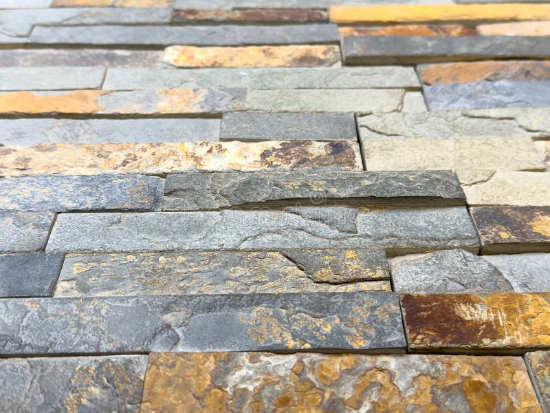 Textured Stone Wall with Multicolored Slate Tiles in Random Patterns ...