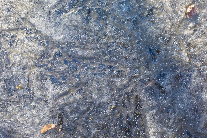 The Textured Surface of an Icy Frozen Pond, Thin Ice with Cracks and a ...