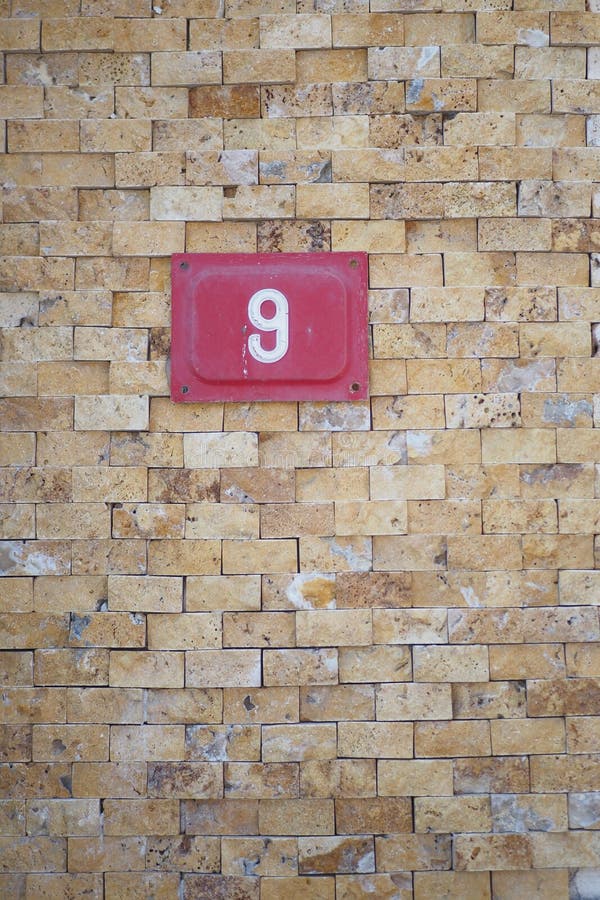 A Textured Wall Features House Number 9 in Bold Red, Creating a ...
