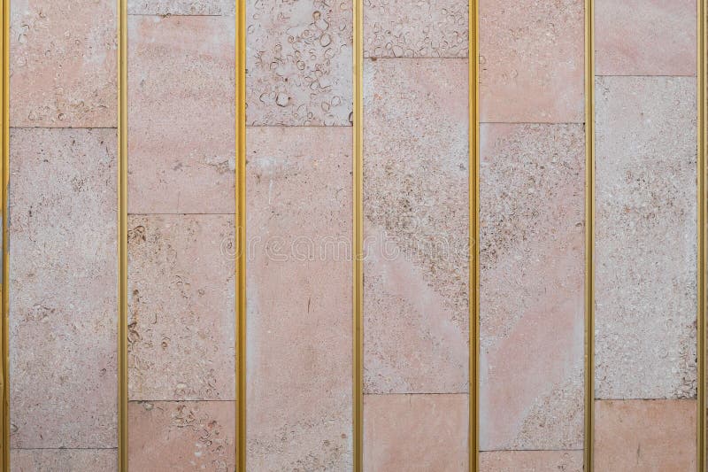 Textured Wall Lined with Shell Rock Tiles and Decorated with Brass ...