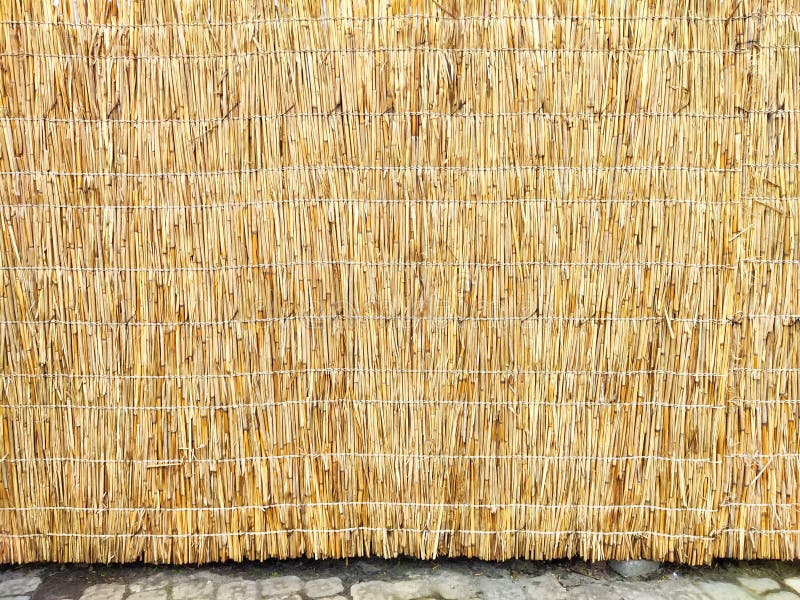 A Textured Wall Made from Tightly Bound Dried Reeds Creates a Rustic ...