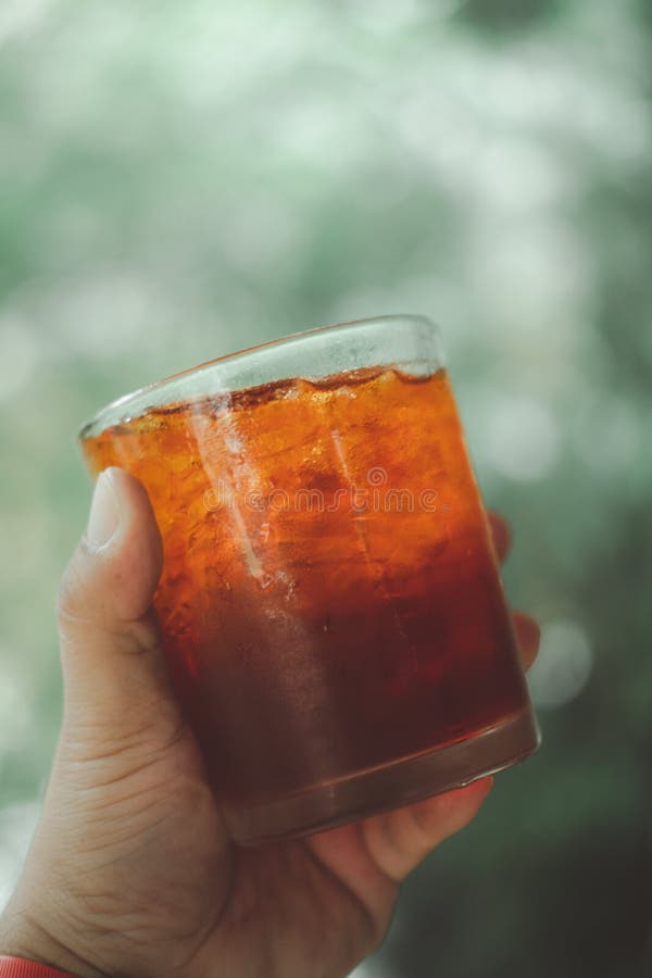 Thai Black Tea with Ice in Glass on Hand Stock Image - Image of healthy ...