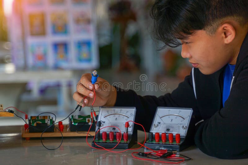 Thai Boy Performs an Outdoor Science Experiment on Connecting a Simple ...