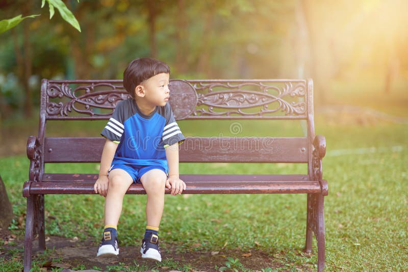 Thai Boy Sit on Bench in Park with Green Botany Background Stock Image ...