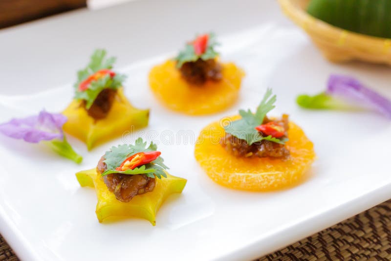 Thai Dessert Name is ` MA HOR ` on the Dish and they are on the Table ...