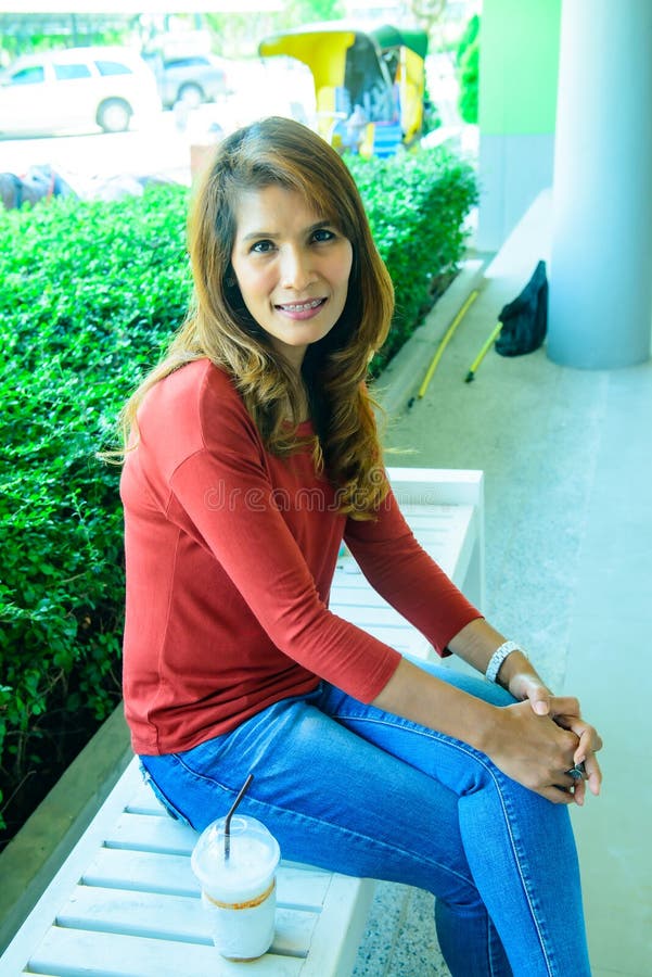 Thai Female on Bench stock image. Image of cafe, bench - 218780803