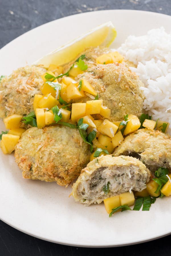 Thai Fish Cakes with Mango Salsa and Rice on a Plate, Close-up Stock ...