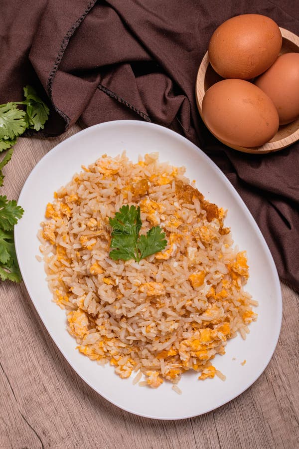 Thai Food Egg Fried Rice in White Plate on Wooden Floor Stock Photo ...