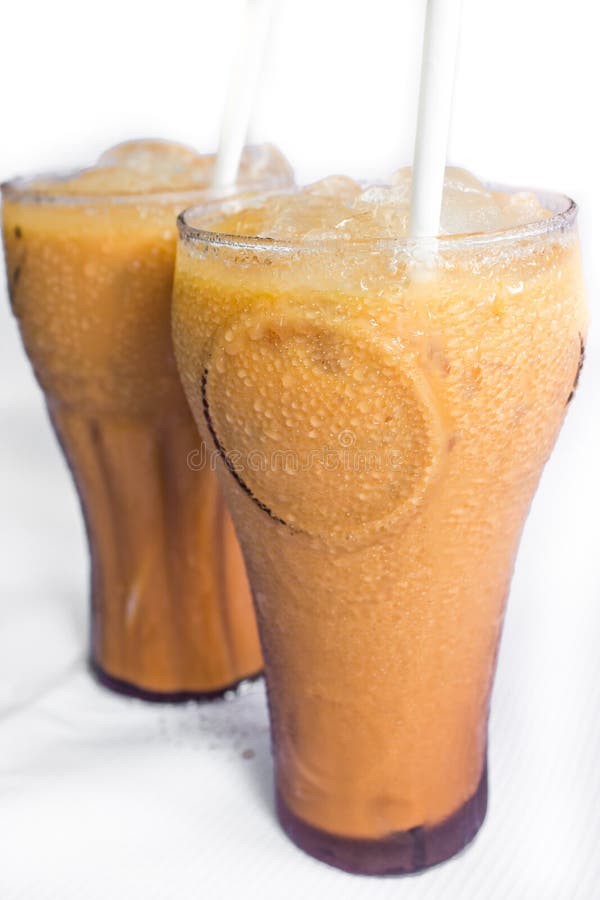 Iced Milk Tea with Tapioca Pearls, Milk Splashes, and Pearls Frozen in ...
