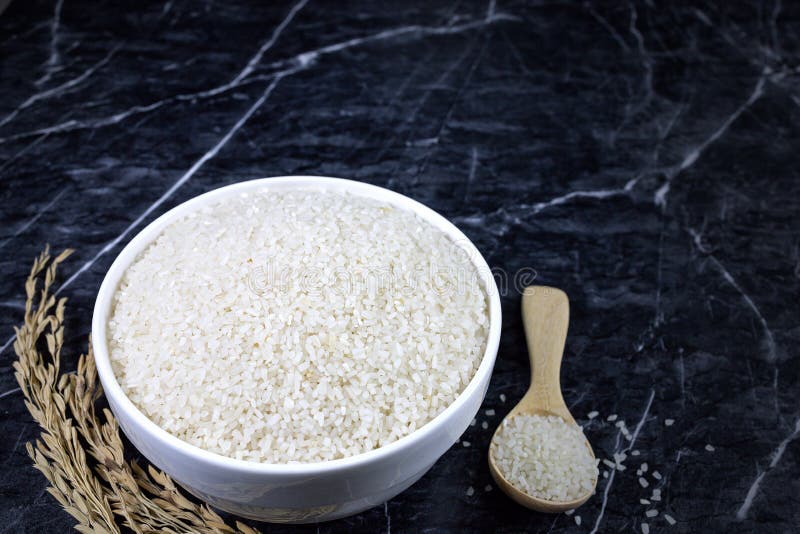 Thai Jasmine Rice Broken Rice in White Ceramic Bowl and Wooden Spoon on ...