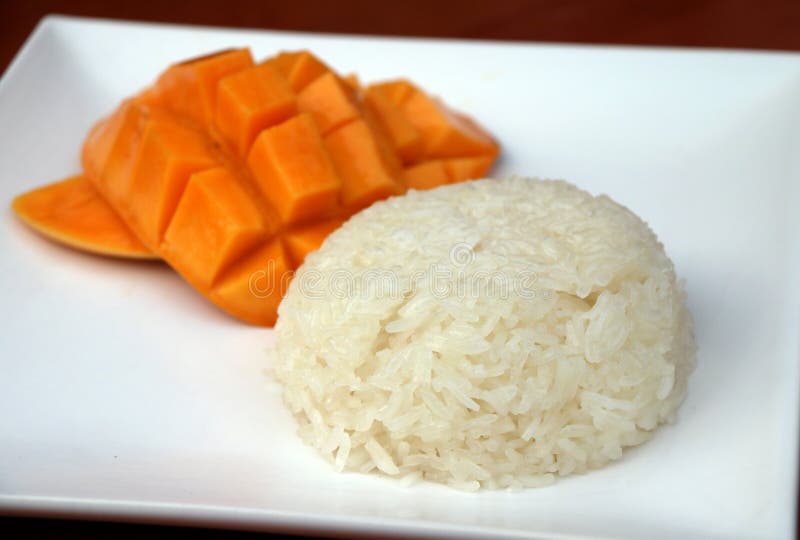 Thai Mango Sticky Rice in the White Square Dish on the Table. Stock ...