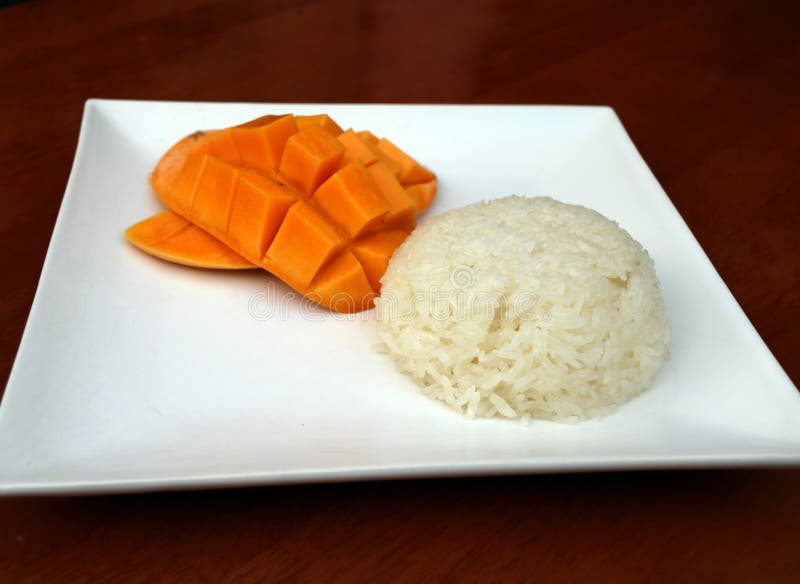 Thai Mango Sticky Rice in the White Square Dish on the Table. Stock ...