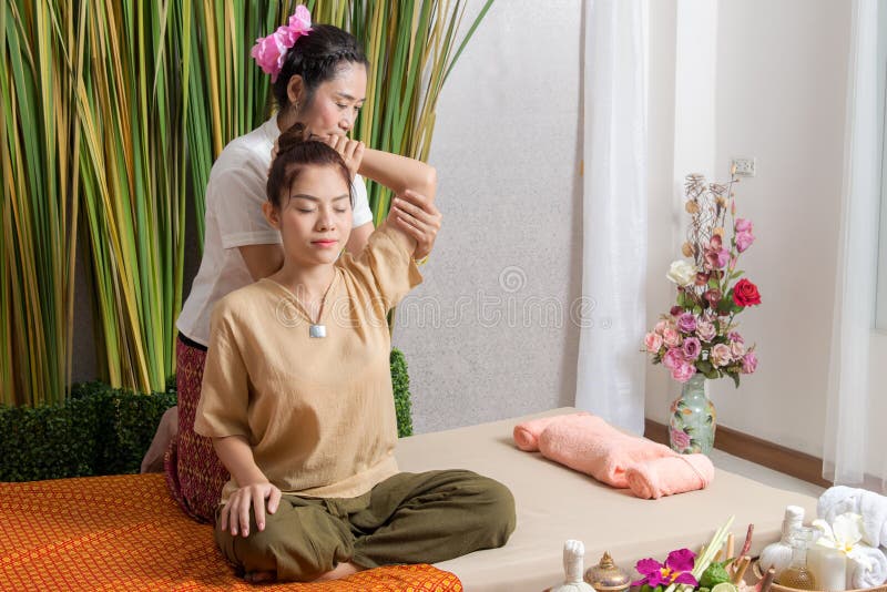 Thai Masseuse Doing Massage For Woman In Spa Salon Asian Beautiful