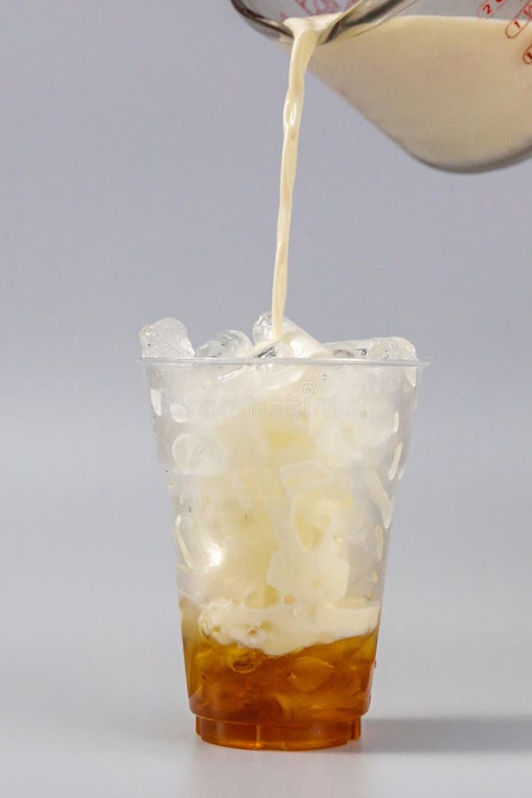 Thai Style Cold Drink in Plastic Glass. Hand Pouring Ingredient into ...