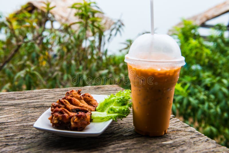 Thai Style Fried Chicken with Iced Milk Tea Stock Photo - Image of ...