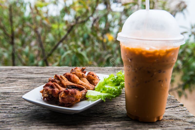 Thai Style Fried Chicken with Iced Milk Tea Stock Photo - Image of ...
