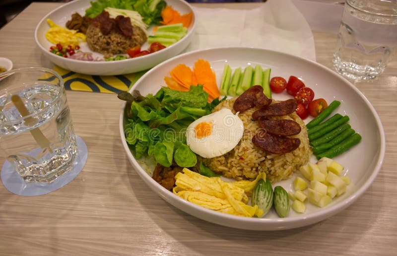 Thai Style Fried Rice with Assorted Sides and Vegetables on the Table ...