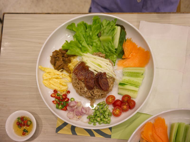 Thai Style Fried Rice with Assorted Sides and Vegetables on the Table ...