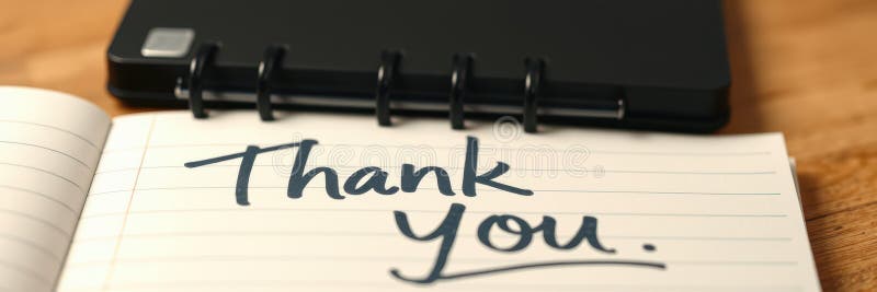 Thank You Note on a Notebook Placed beside a Closed Black Planner on a ...