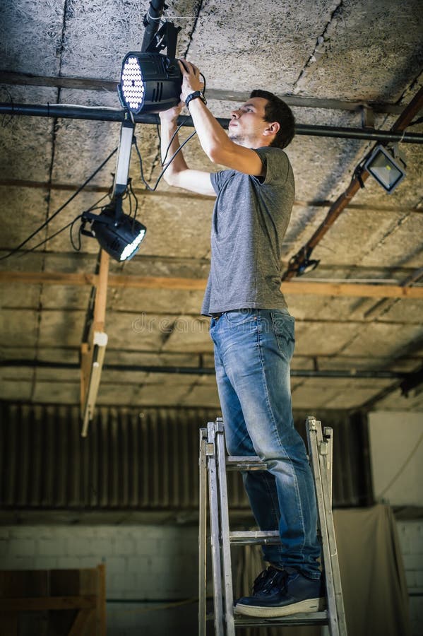 Lighting Technician Electric Engineer Adjusting Focus of Lighting ...
