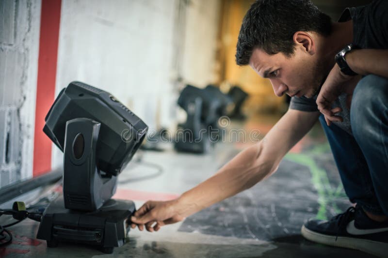Behind the Scene. Lighting Technician Electric Engineer Adjusting Stage ...