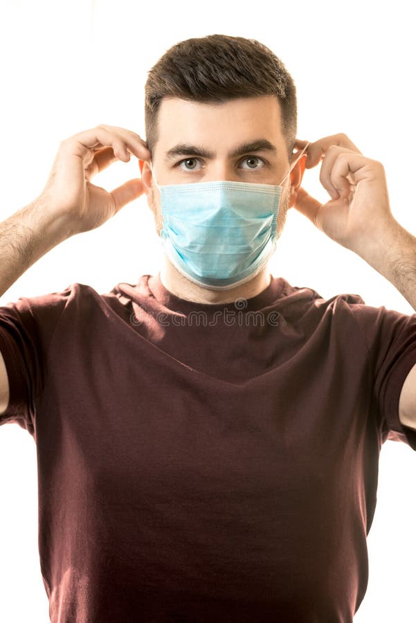 Theme of Coronavirus and Safety. a Young Man is Putting on a Blue Virus ...