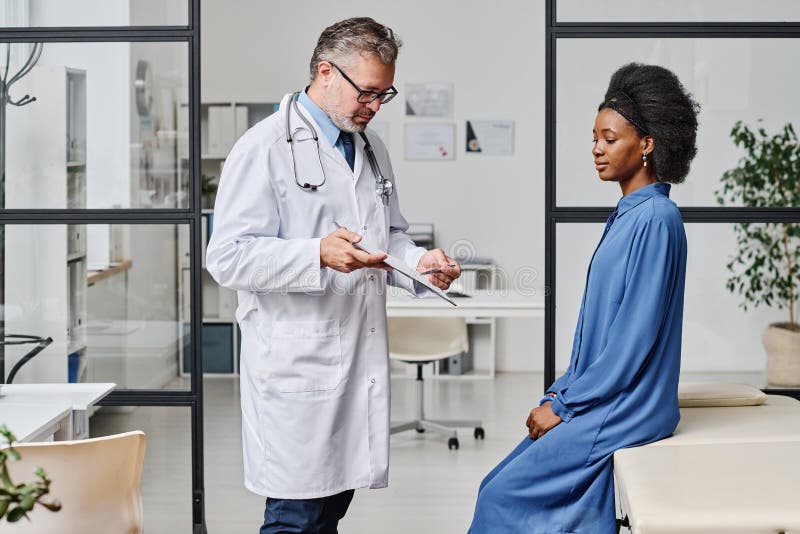 Therapist Explaining Treatment with Patient Stock Photo - Image of ...