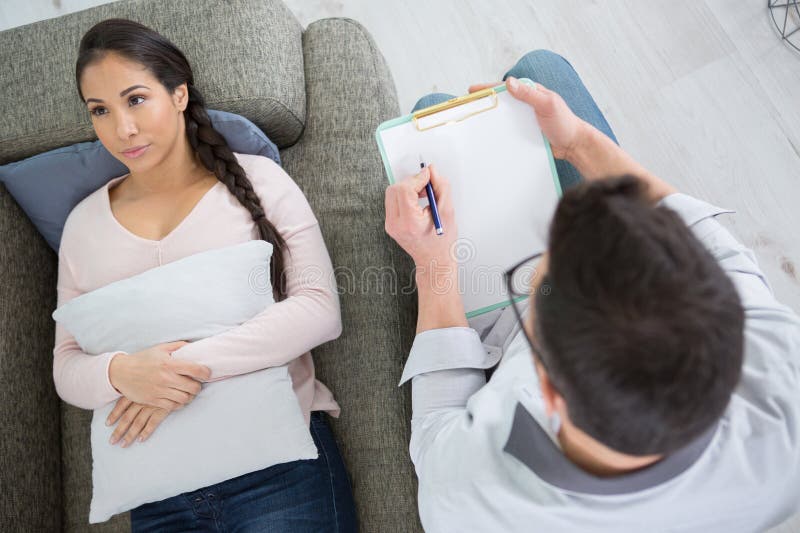 Therapist Making Notes while Listening To Stressed Client Stock Photo ...