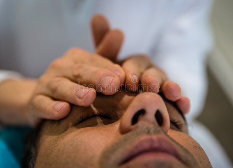 A Therapist Puts His Hands on a Man`s Forehead Stock Photo - Image of ...