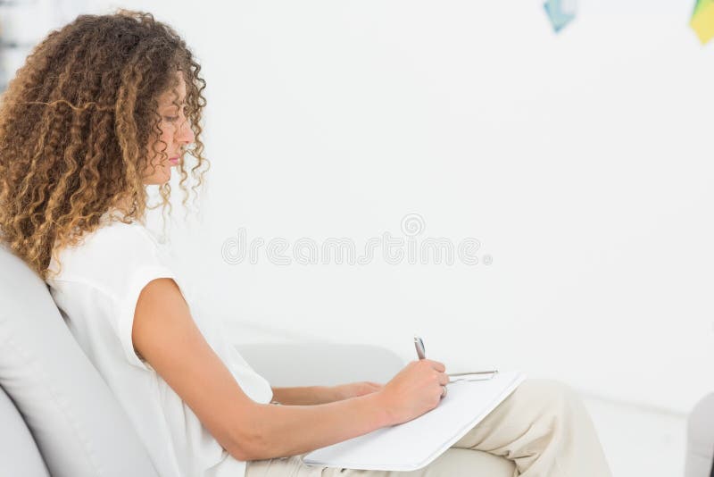 Therapist Taking Notes on Clipboard Sitting on Couch Stock Image ...
