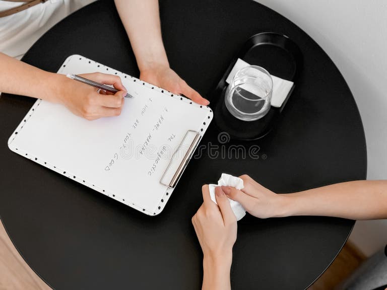 Therapy Session with Counselor Taking Notes and Client Holding Tissues ...