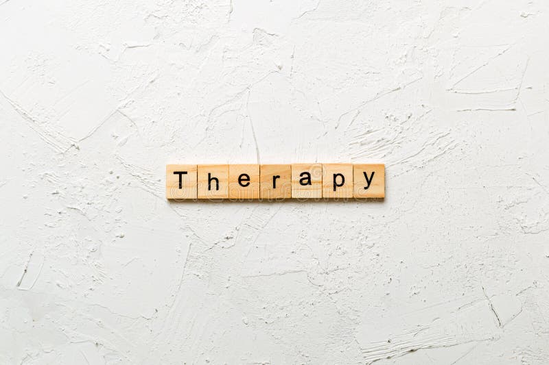 Therapy Word Written on Wood Block. Therapy Text on Cement Table for ...