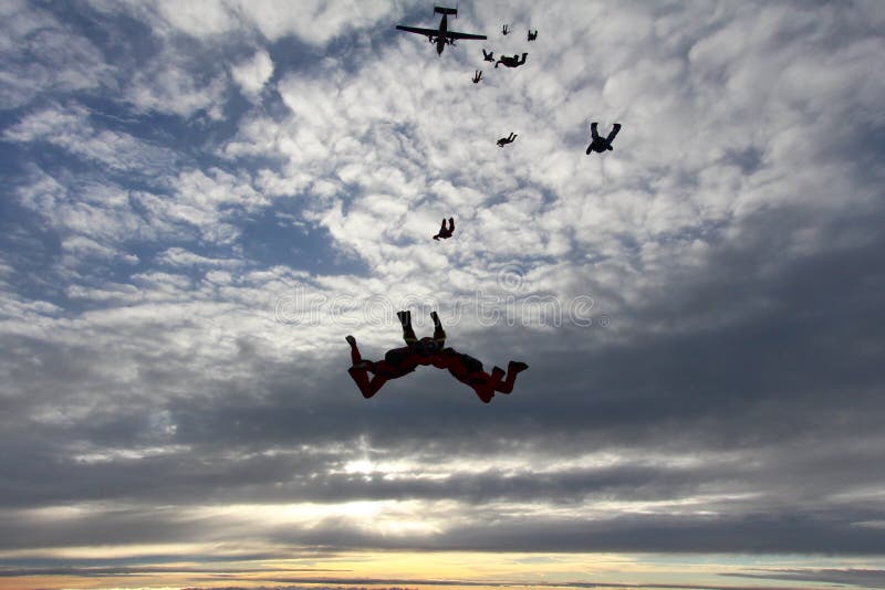 Skydivers are Jumping Out of a Plane into Amazing Sky. Stock Image ...
