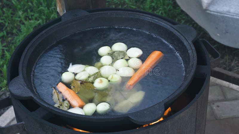 There is a Brazier with Water and Vegetables on the Fire. Stock Footage ...