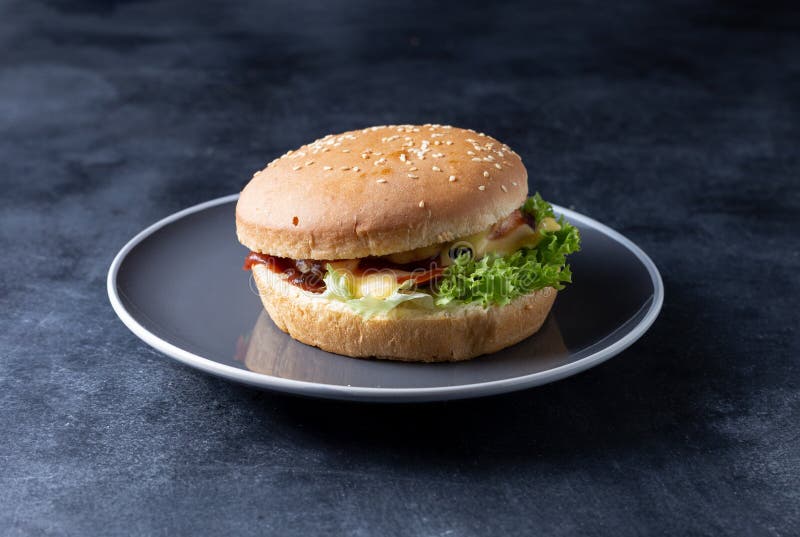 There is a Burger on the Table in a Plate. Stock Image - Image of ...