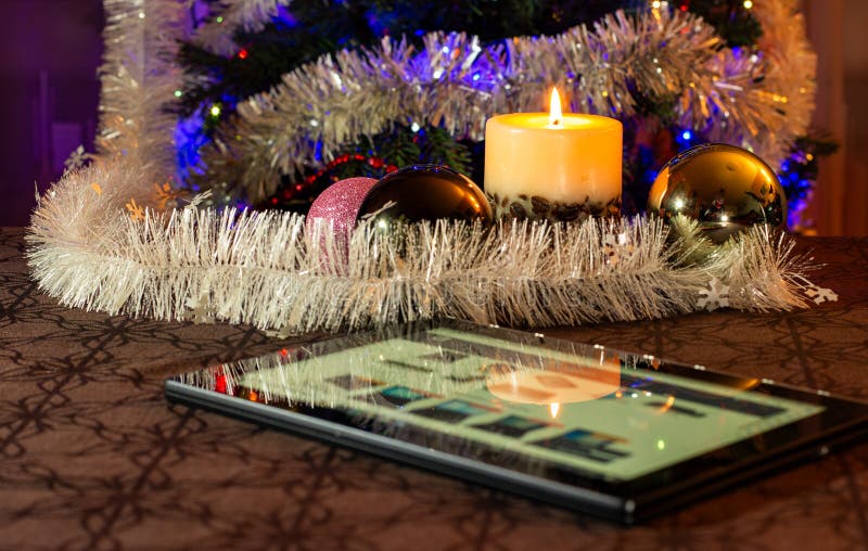 On the Table There is a Candle and a Tablet Stock Image - Image of ...