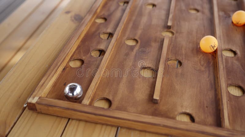 A Wooden Maze with Shiny Balls on a Classic Wooden Table. Creative ...